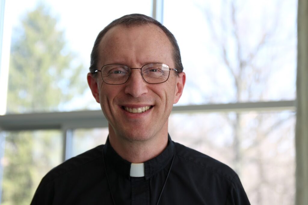 Fr. John Herman, CSC (with trees in background) - Sainte Anne de Detroit